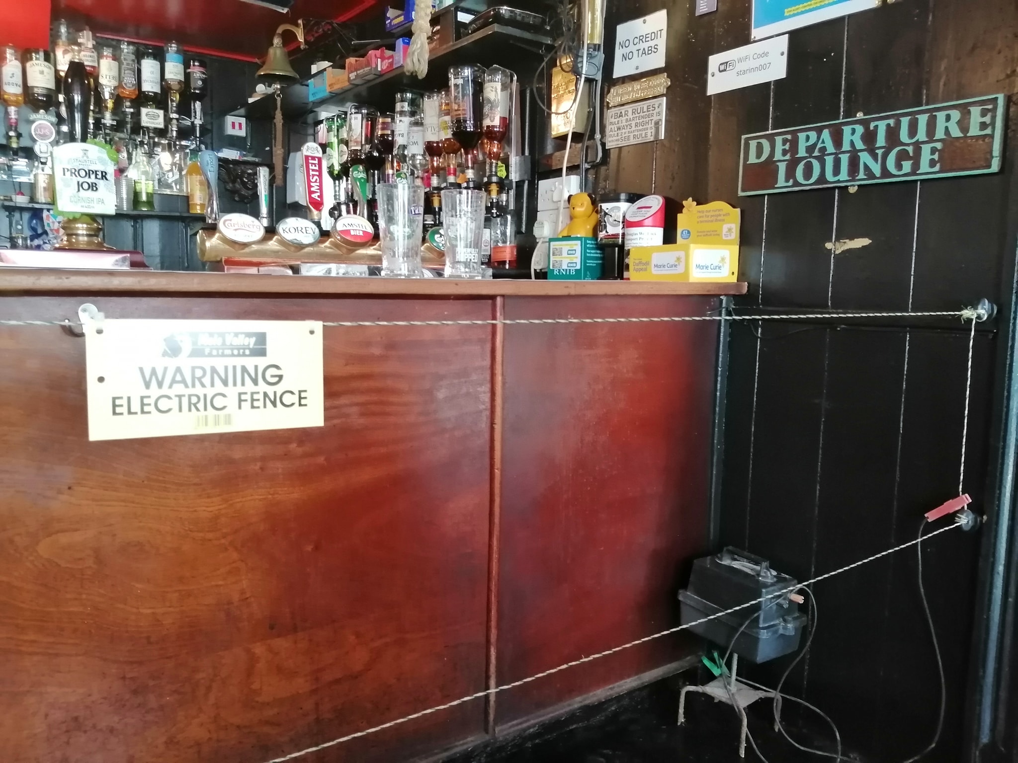 Pub installs electric fence to ensure social distancing at bar ...